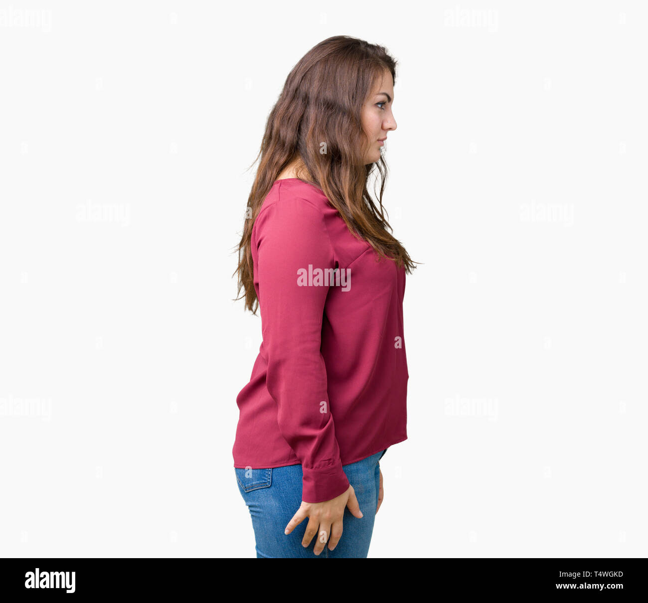Beautiful plus size young woman over isolated background looking to ...