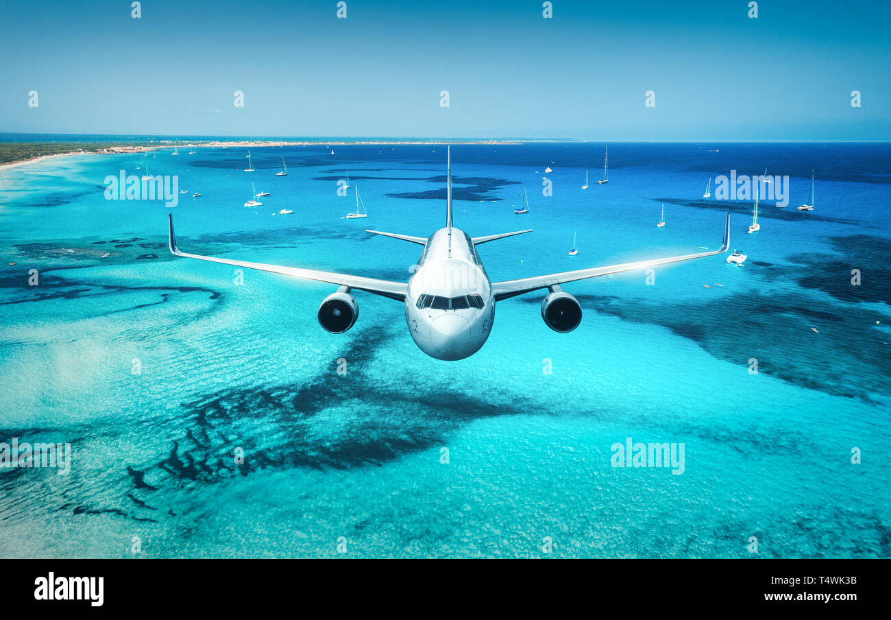 Airplane is flying over islands and sea at sunrise in summer. Landscape ...