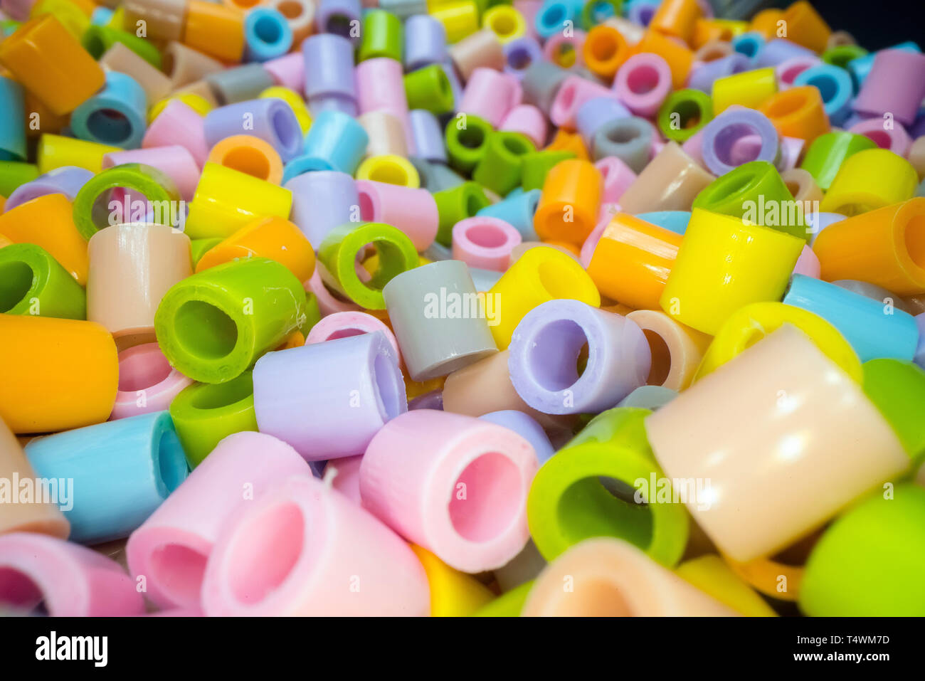 Short plastic tube pieces stacked on top of each other. Plastic waste ...