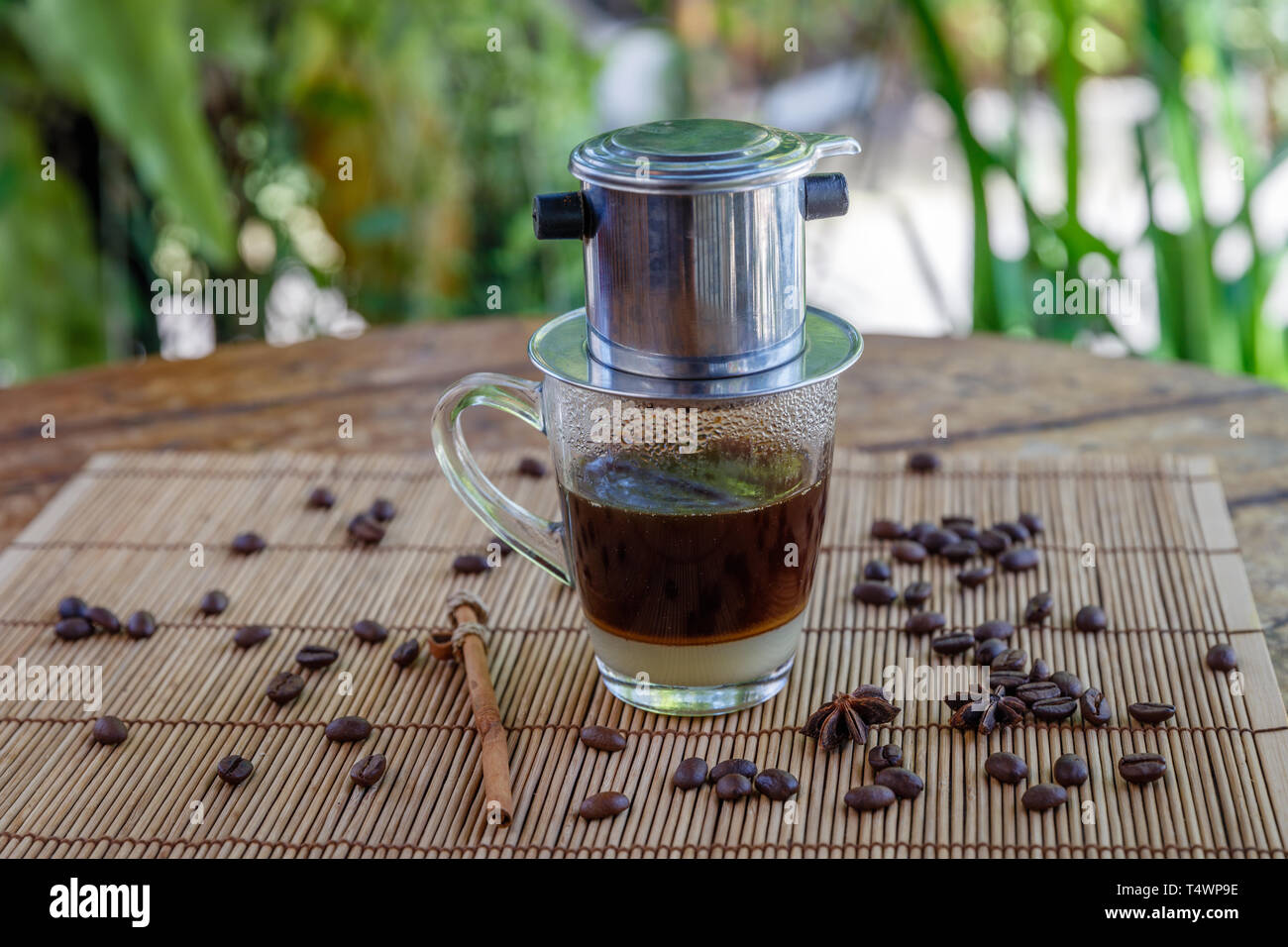 Vietnamese traditional drip filter coffee with sweet condensed milk in ...
