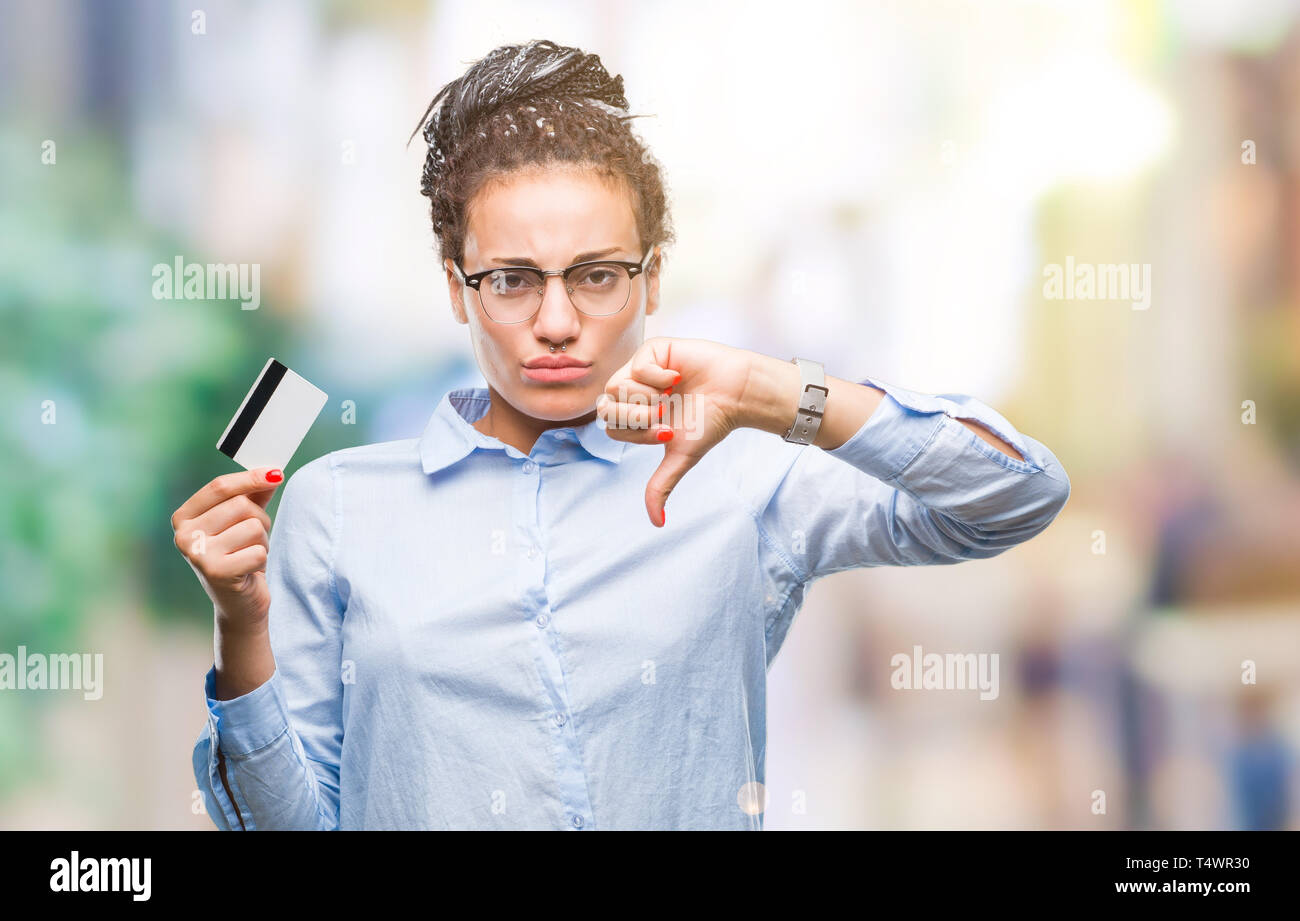 Young african american girl holding credit card over isolated ...