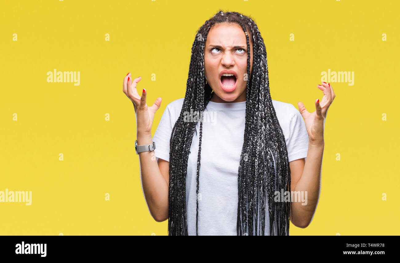 Young braided hair african american girl over isolated background crazy ...