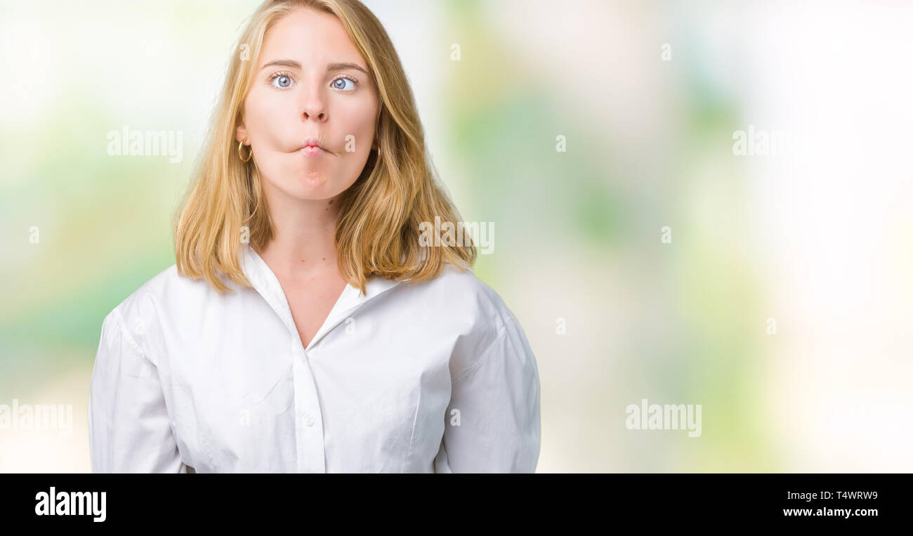 Beautiful young business woman over isolated background making fish ...