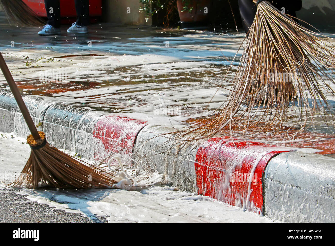 Close up broom worker cleaning dirty footpath Stock Photo - Alamy
