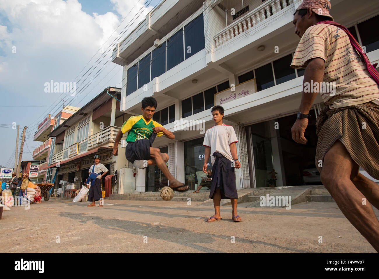 Burmese men playing Chin Lone in the street in Kalaw, Shan State ...