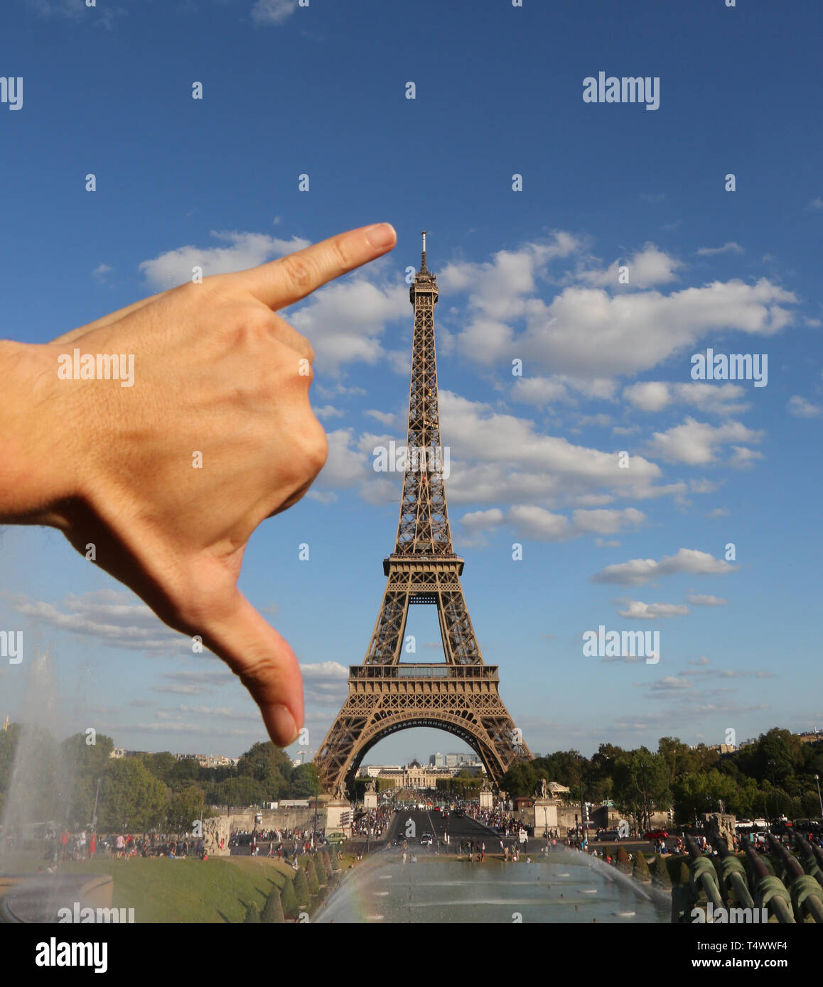 hand of man and measures the Eiffel Tower in Paris France Stock Photo ...