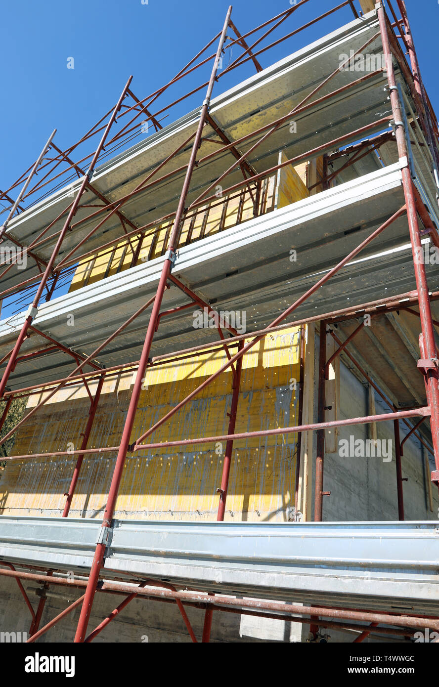 building under construction on a construction site surrounded by a high ...