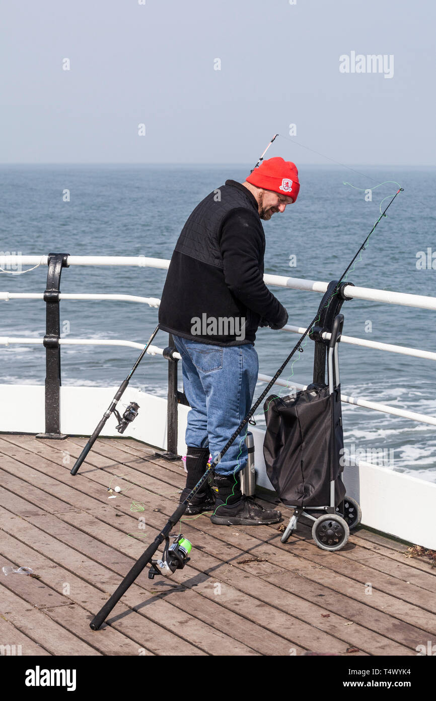 A man stood on the pier fishing at Saltburn by the Sea,England,UK Stock ...