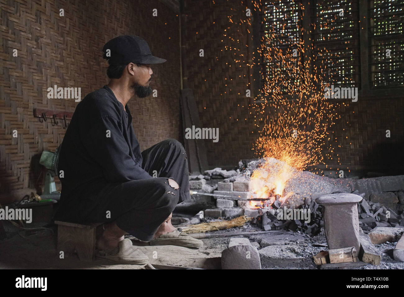 A blacksmith preparing fire with traditional tools to make Keris ...