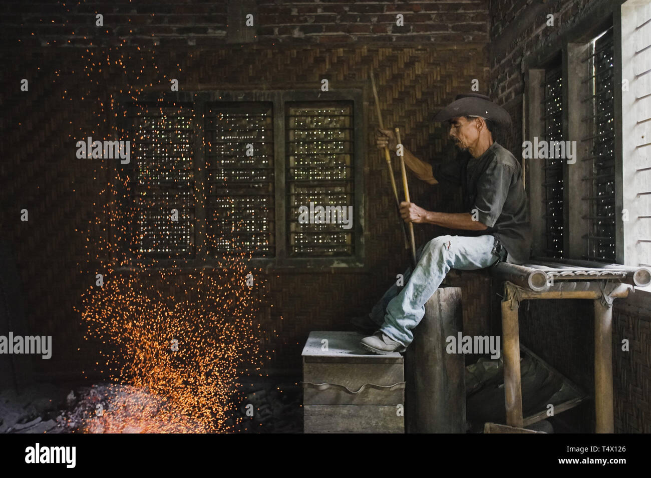 A blacksmith preparing fire with traditional tools to make Keris ...
