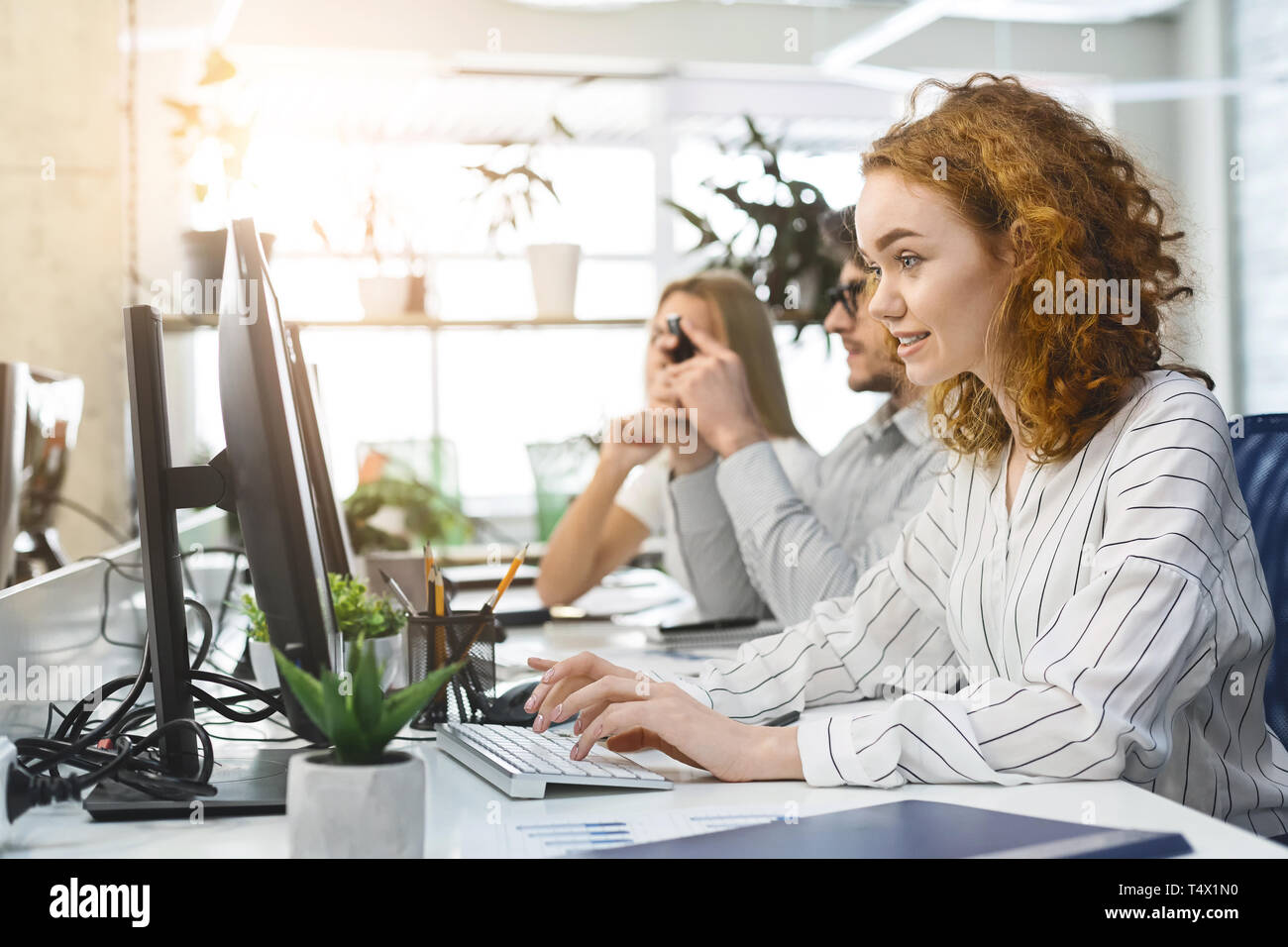 Young busy staff of employees working on computers Stock Photo - Alamy