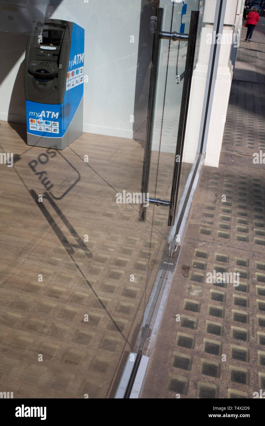 A my ATM cash dispenser in the window of a Knightsbridge money changer ...