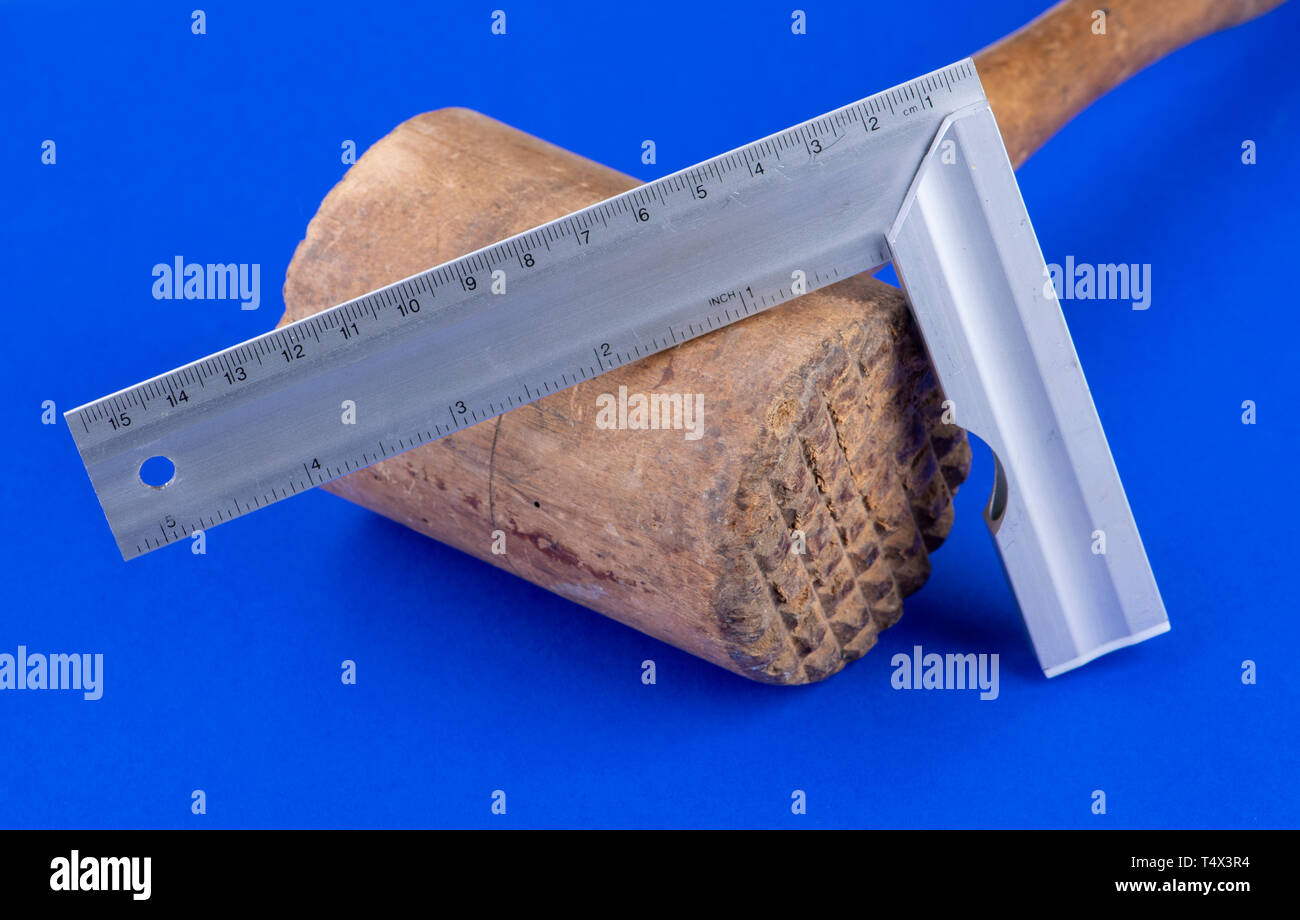 Wooden hammer with angle ruler on blue background Stock Photo - Alamy