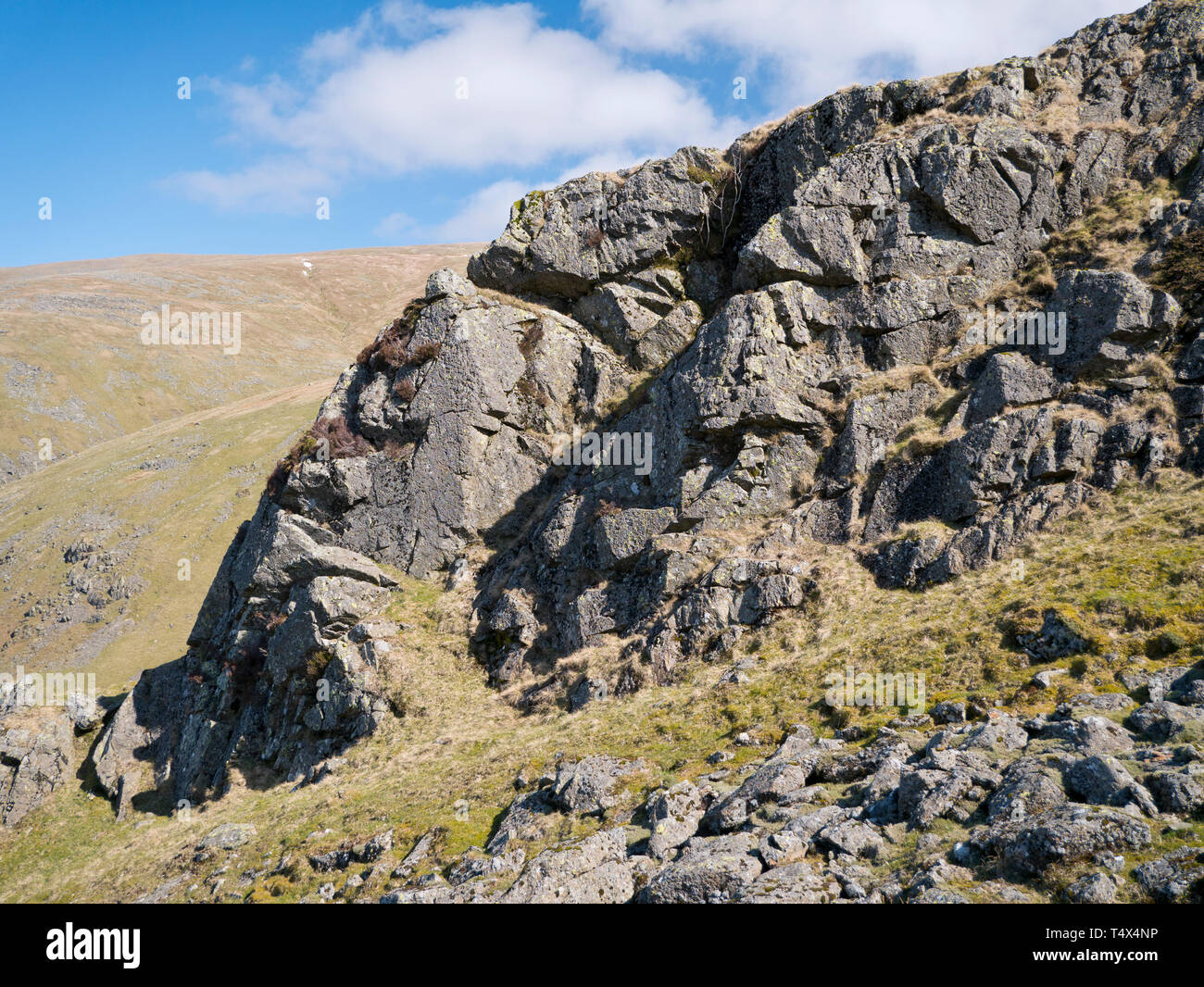 Against a blue sky, an igneous rock outcrop near Comb Crags, Birk Side ...