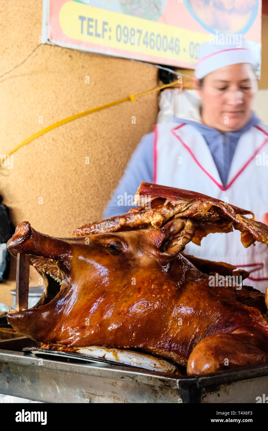 Fresh roasted whole pig for sale at local farmers market at Ecuador ...