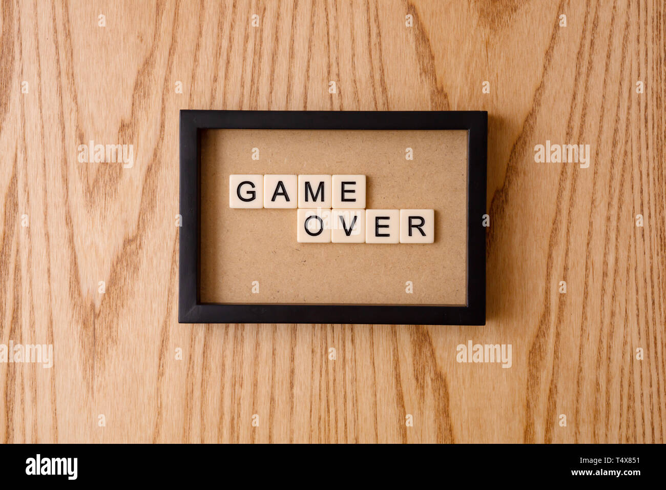 GAME OVER word block on wood background Stock Photo - Alamy