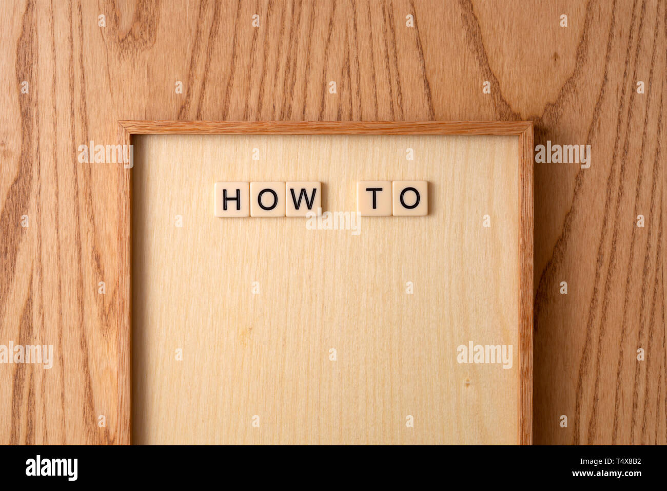 HOW TO word block on wood background Stock Photo - Alamy