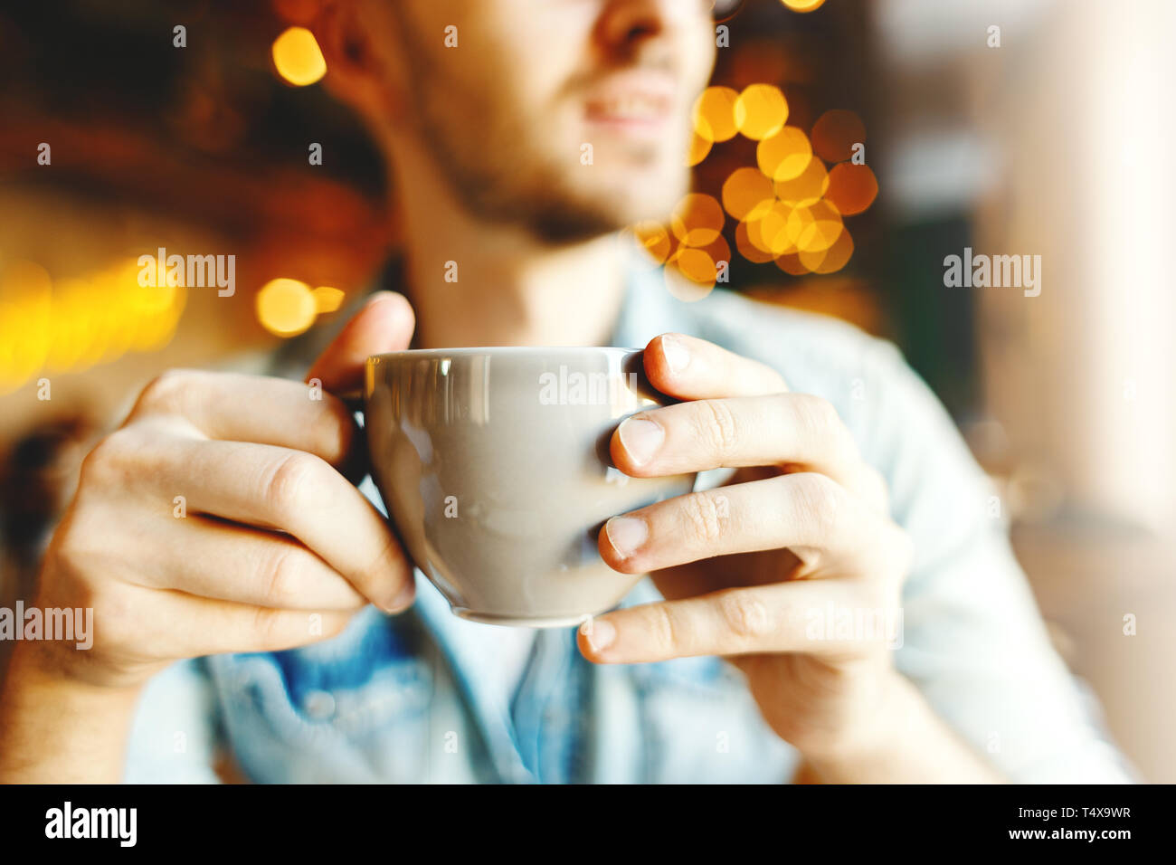 Hands around cup hi-res stock photography and images - Alamy