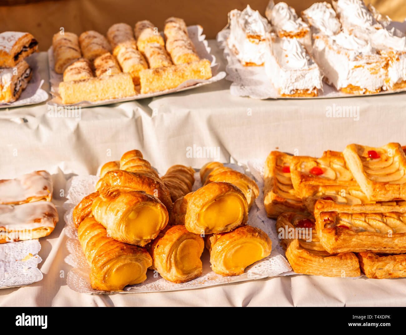 various types of baked and fried cakes sold on the stall in the street ...