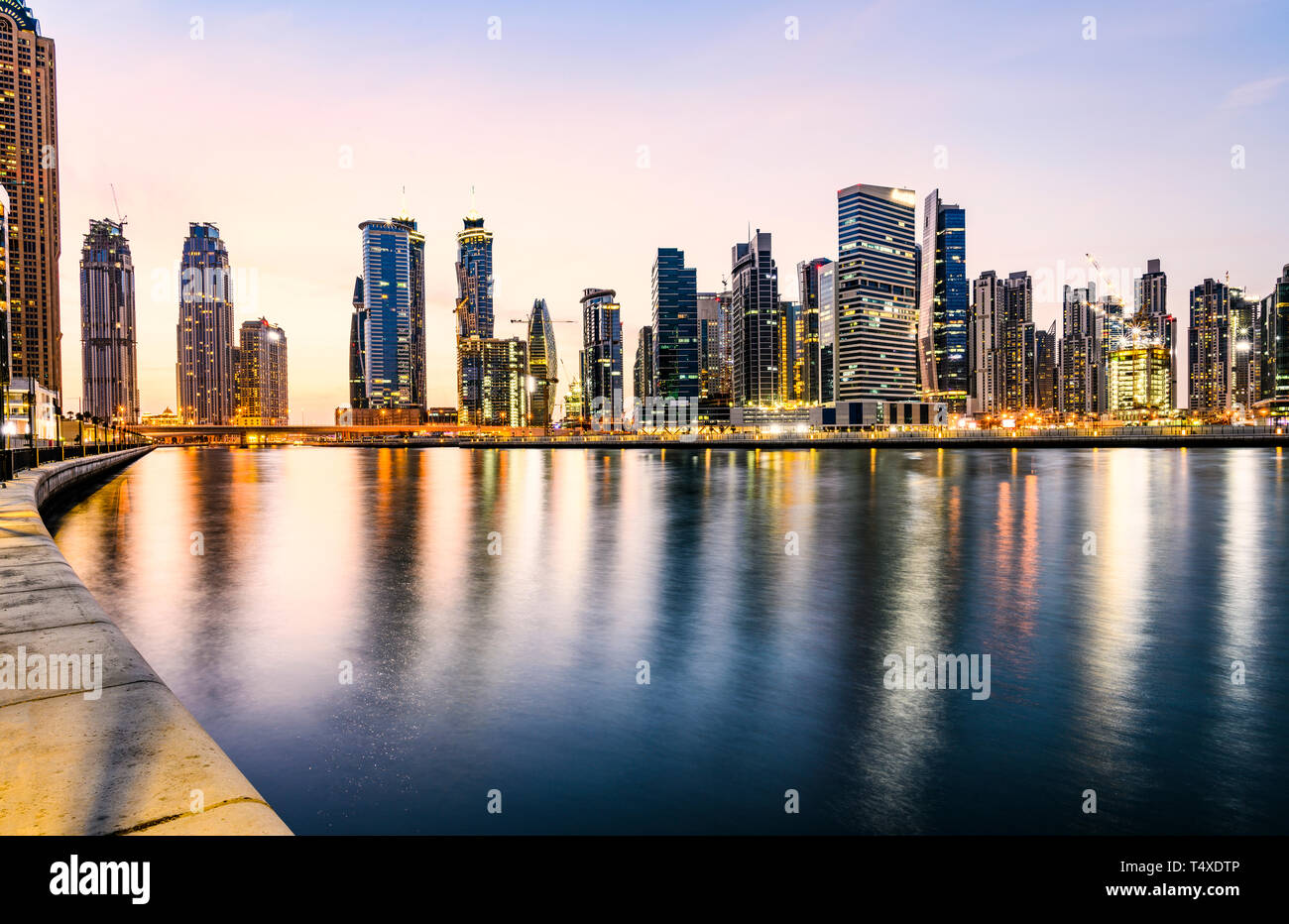 Stunning view of the illuminated Dubai skyline during sunset buildings ...