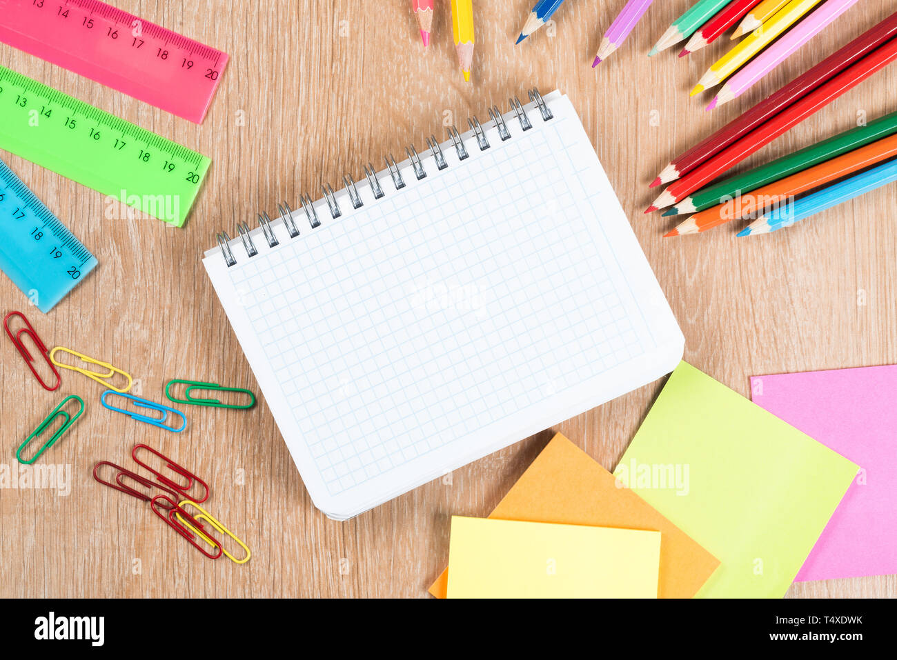 Stationery stuff on wooden table from top view as back to school idea ...