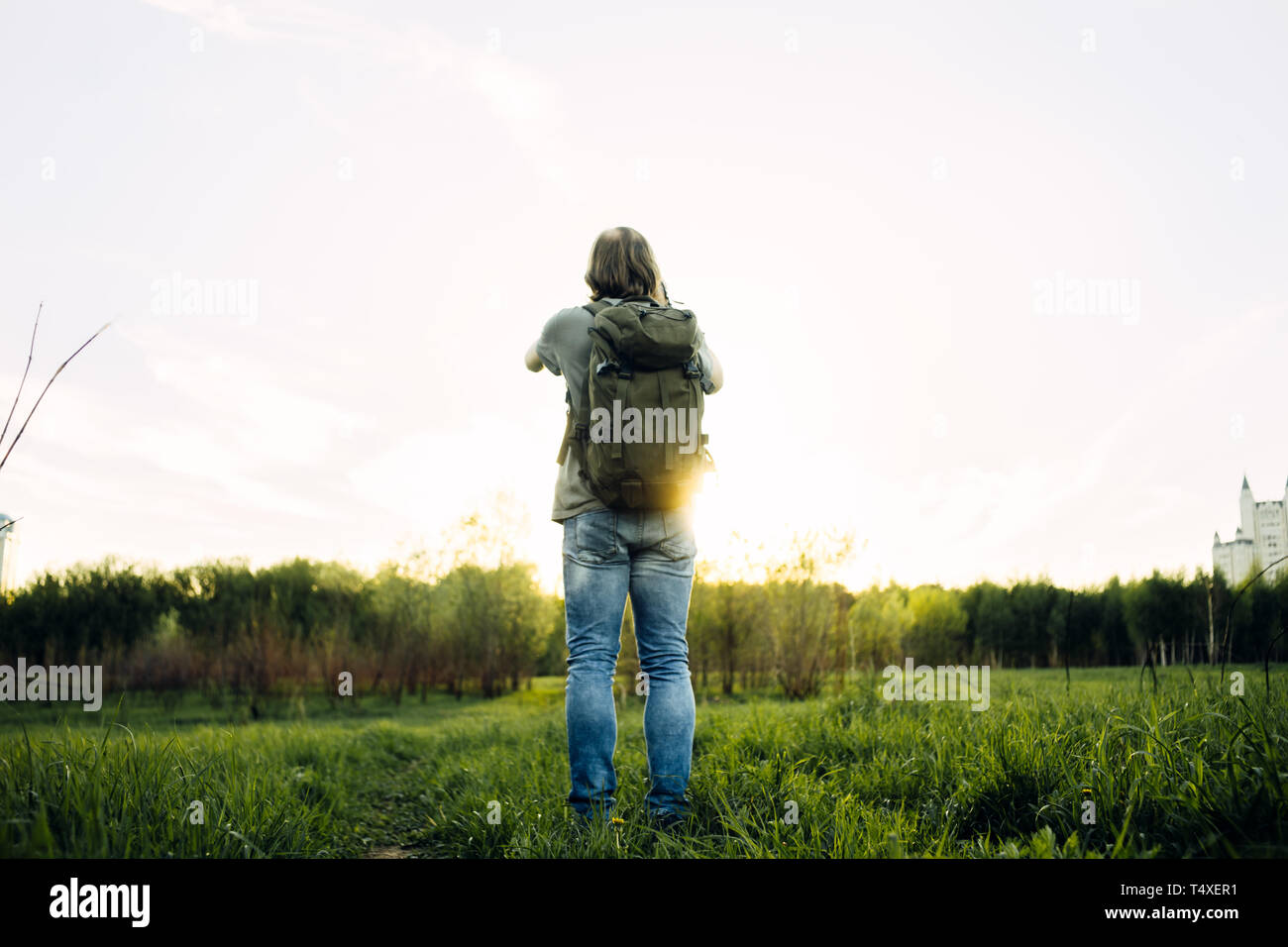 A man with a backpack on his back against the backdrop Stock Photo - Alamy