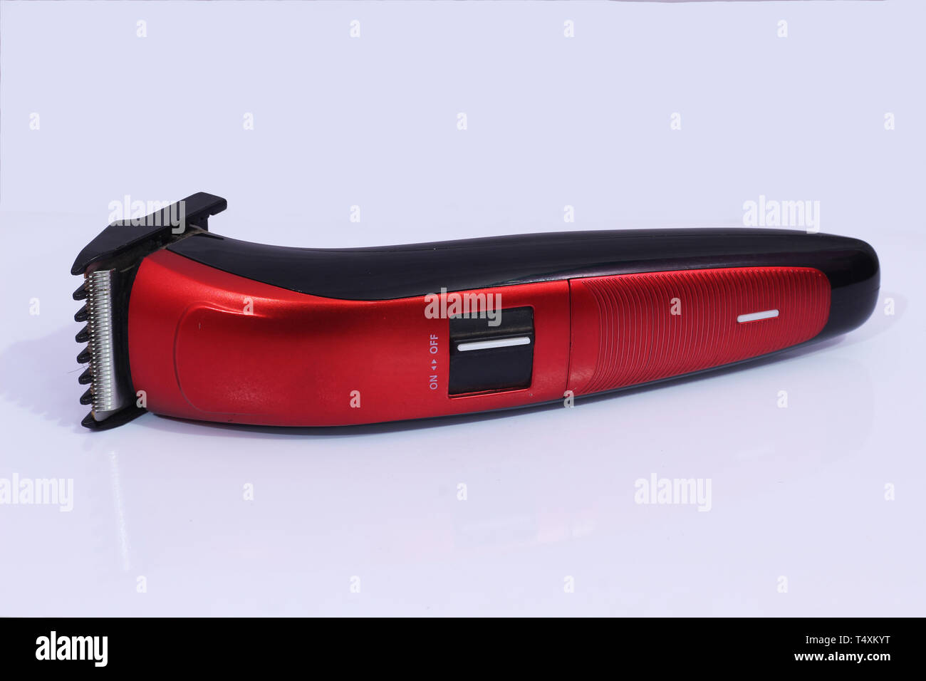 Red color trimmer shaver with white isolated background Stock Photo - Alamy