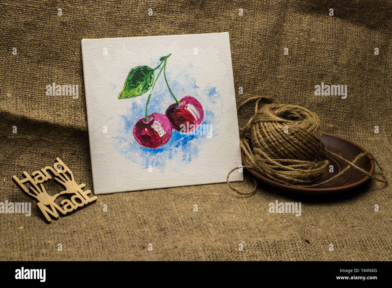 Cherry painting on brown rough sack background with a hand made sign ...