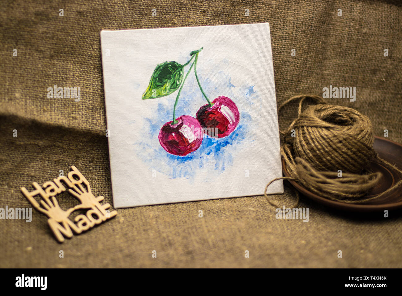 Cherry painting on brown rough sack background with a hand made sign ...