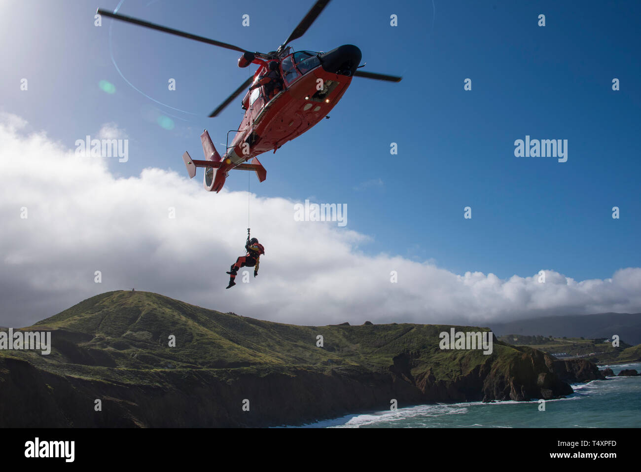 Aircrew members from Coast Guard Air Station San Francisco lower a ...