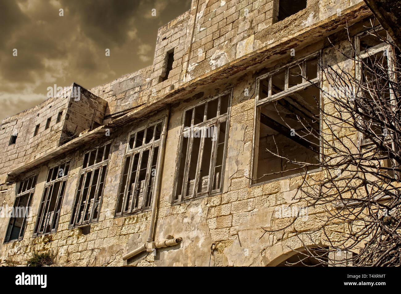 Abandoned Building in sepia. A facade and old windows within an ...