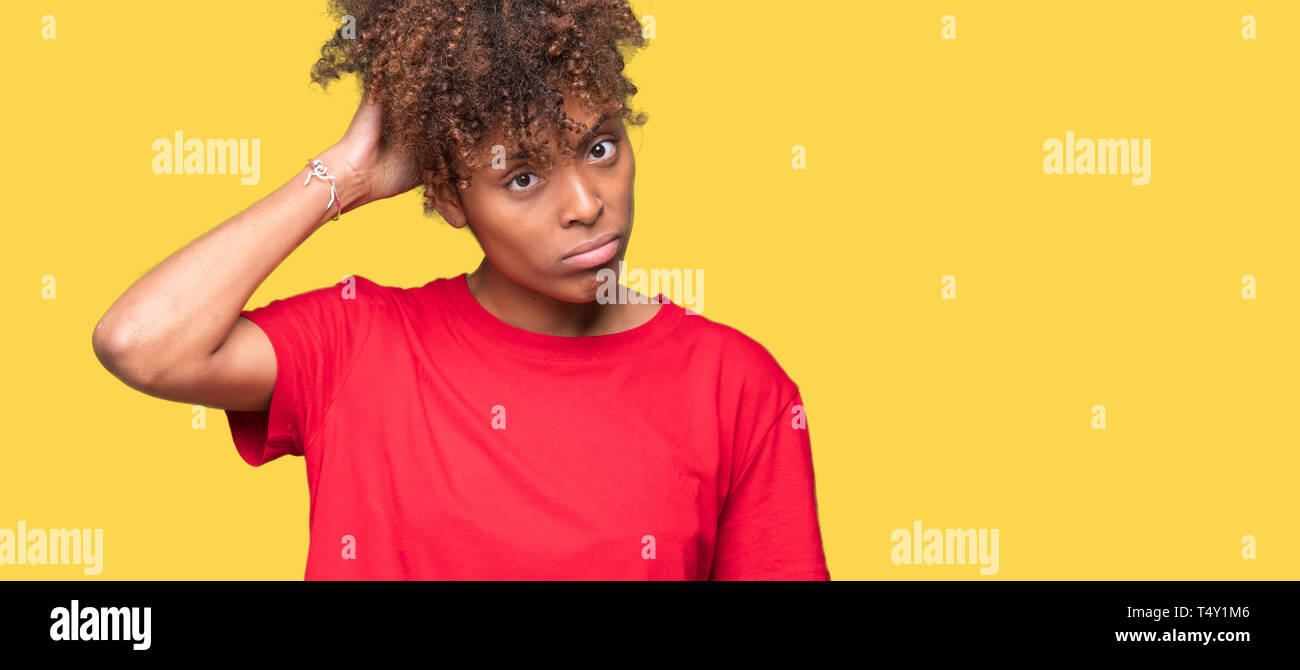 Beautiful young african american woman over isolated background confuse ...