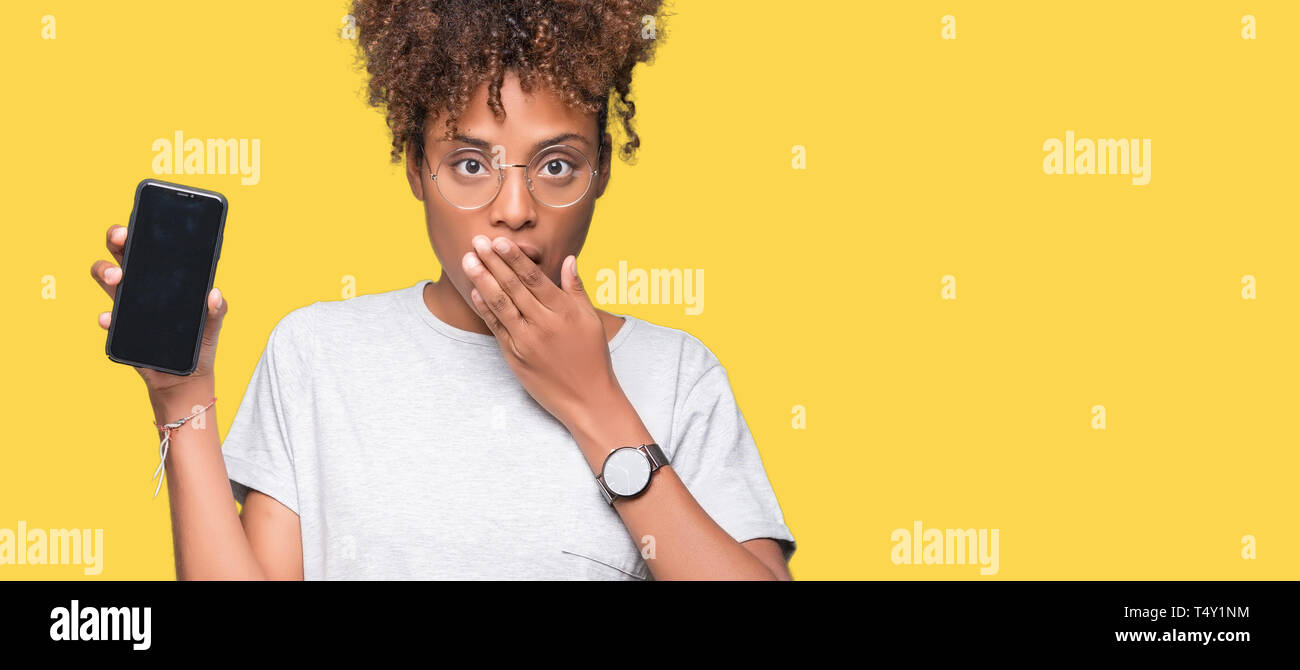 Young african american woman showing smartphone screen over isolated ...