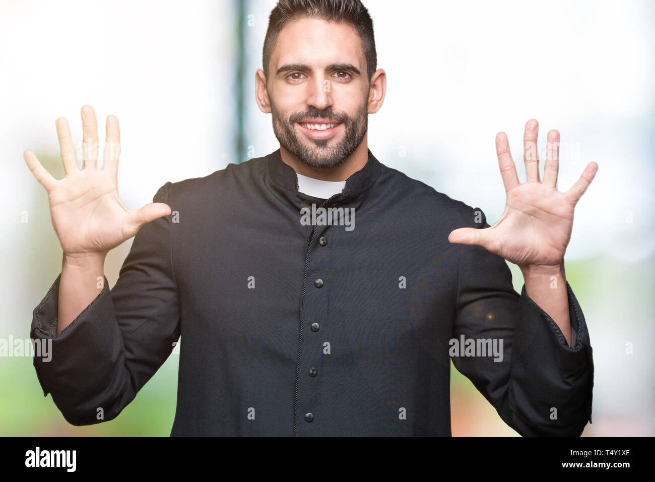 Young Christian priest over isolated background showing and pointing up ...