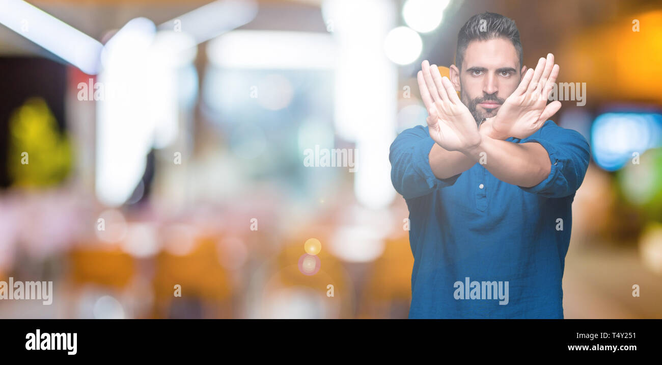 Young handsome man over isolated background Rejection expression ...
