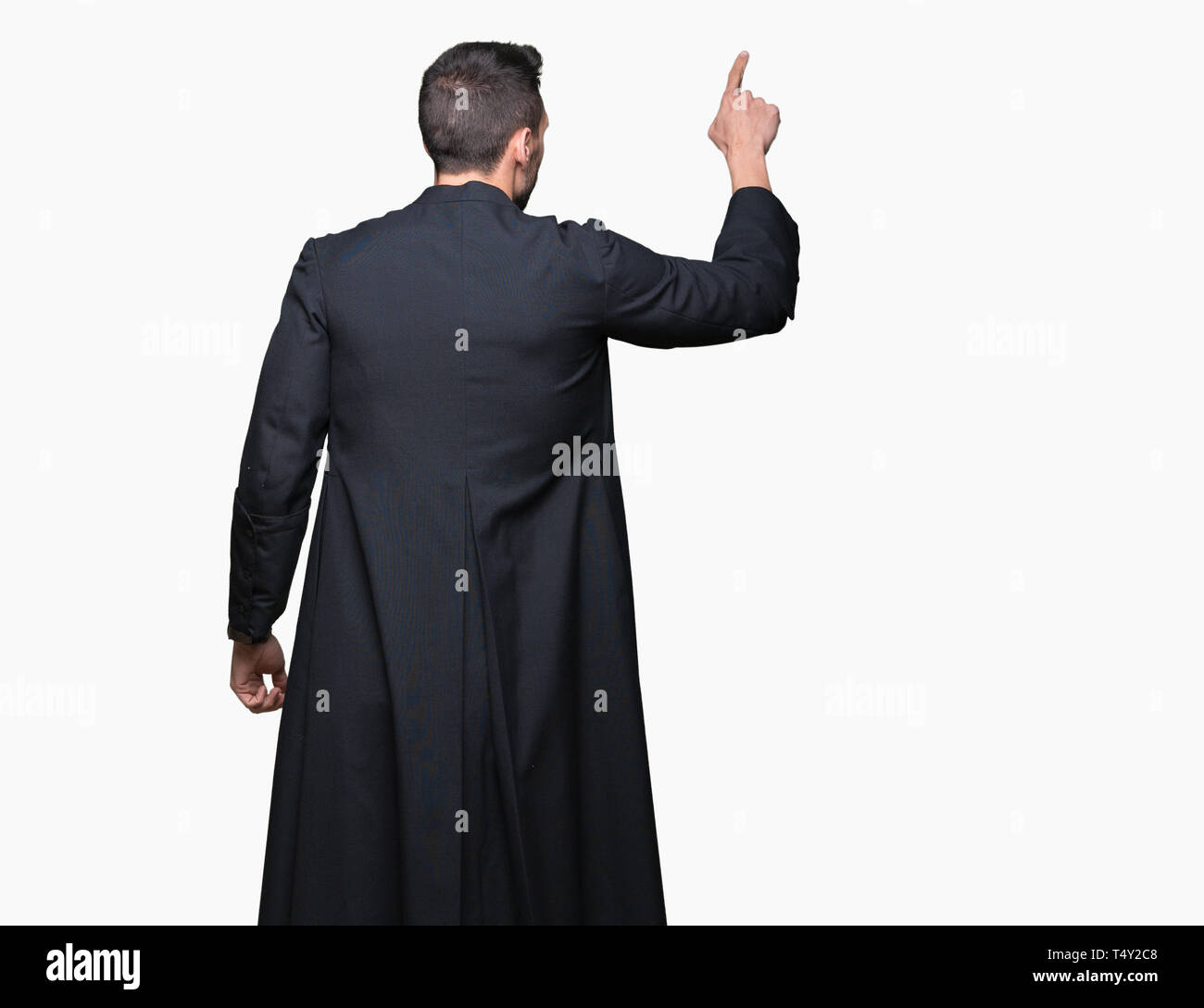 Young Christian priest over isolated background Posing backwards ...