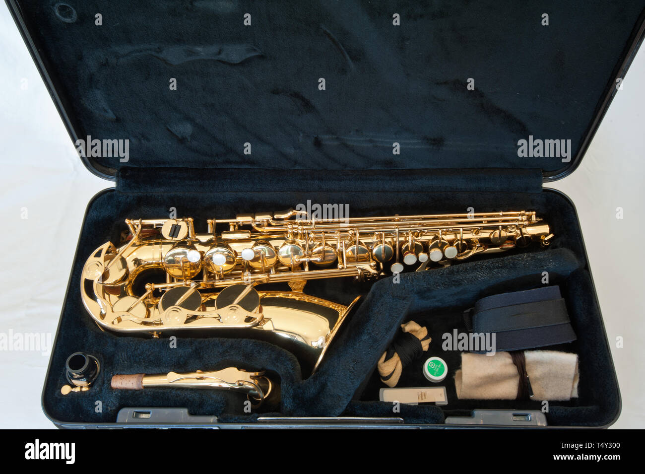A gold / brass alto saxophone on white background with pearl keys ...