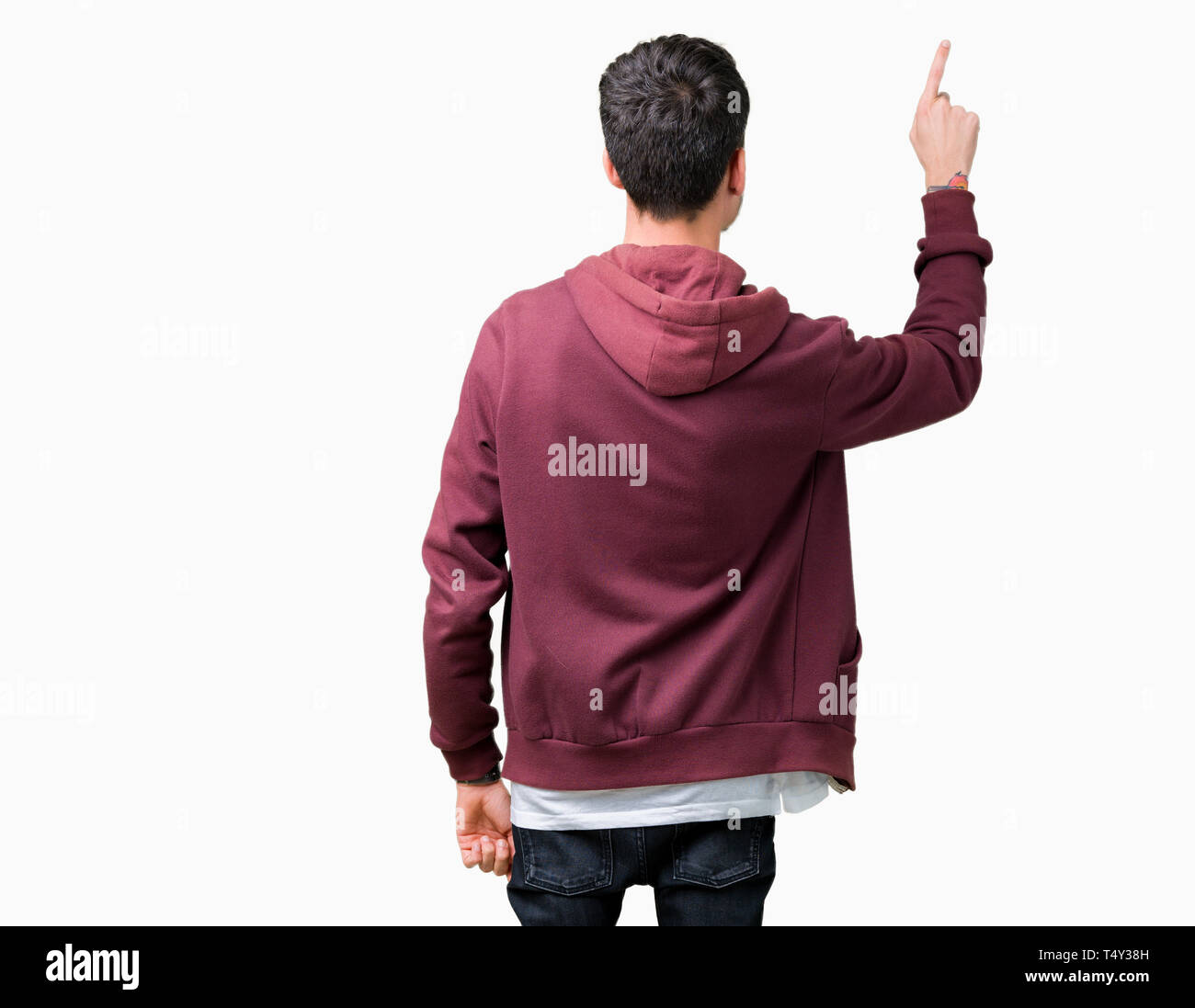 Young handsome man over isolated background Posing backwards pointing ...