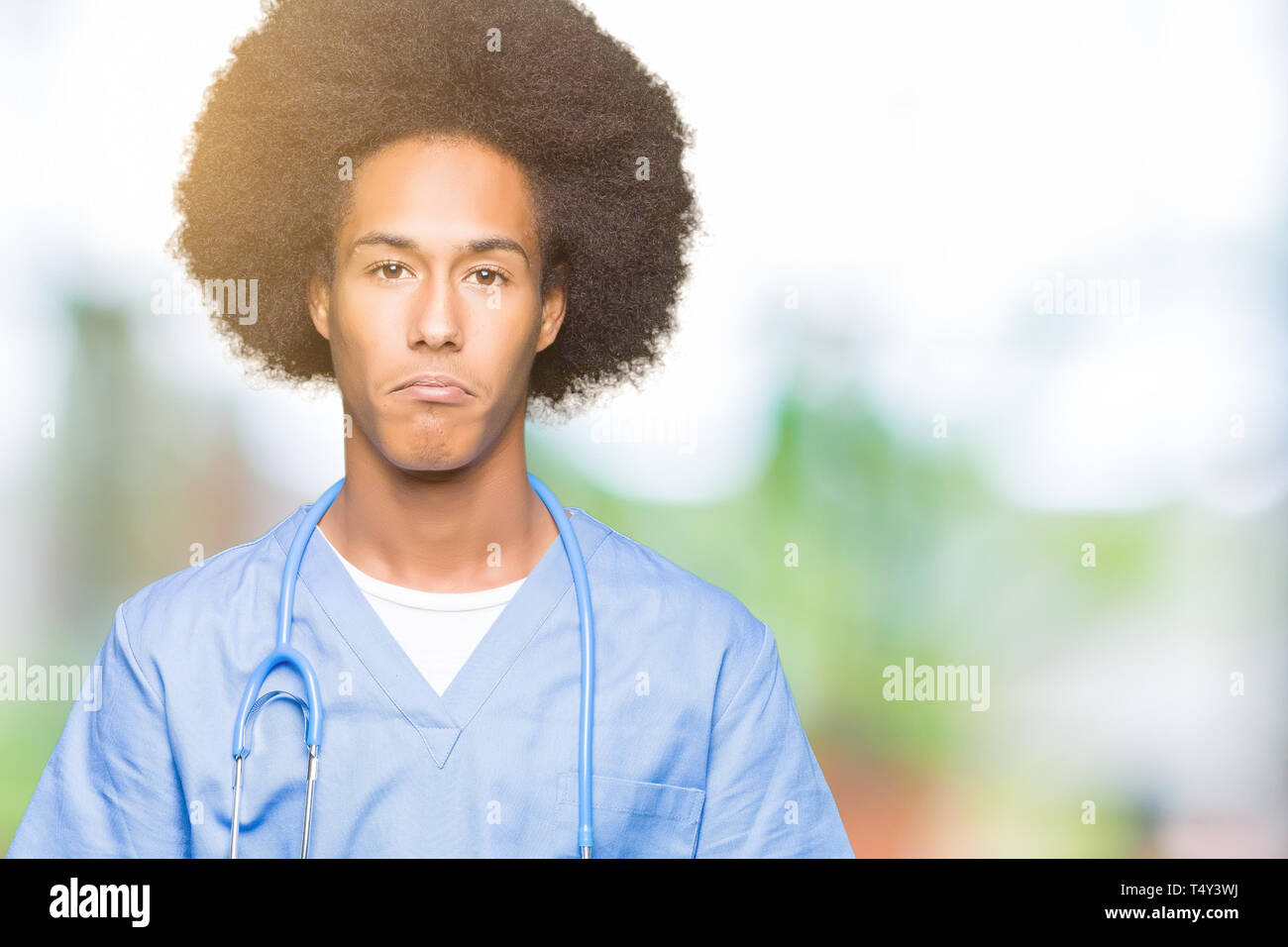 Young african american doctor man with afro hair depressed and worry ...