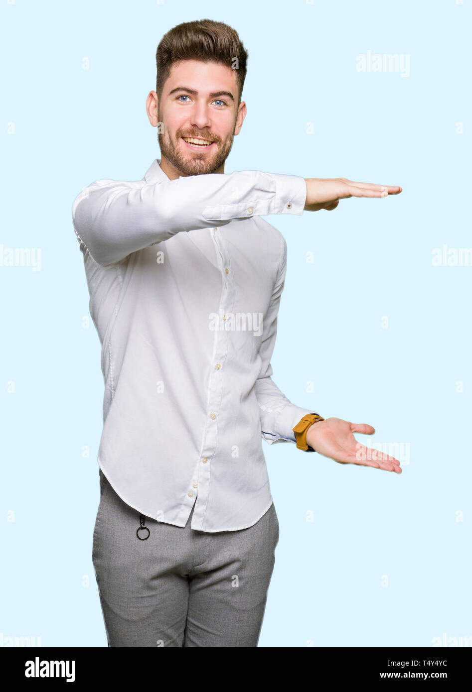 Young handsome business man gesturing with hands showing big and large ...
