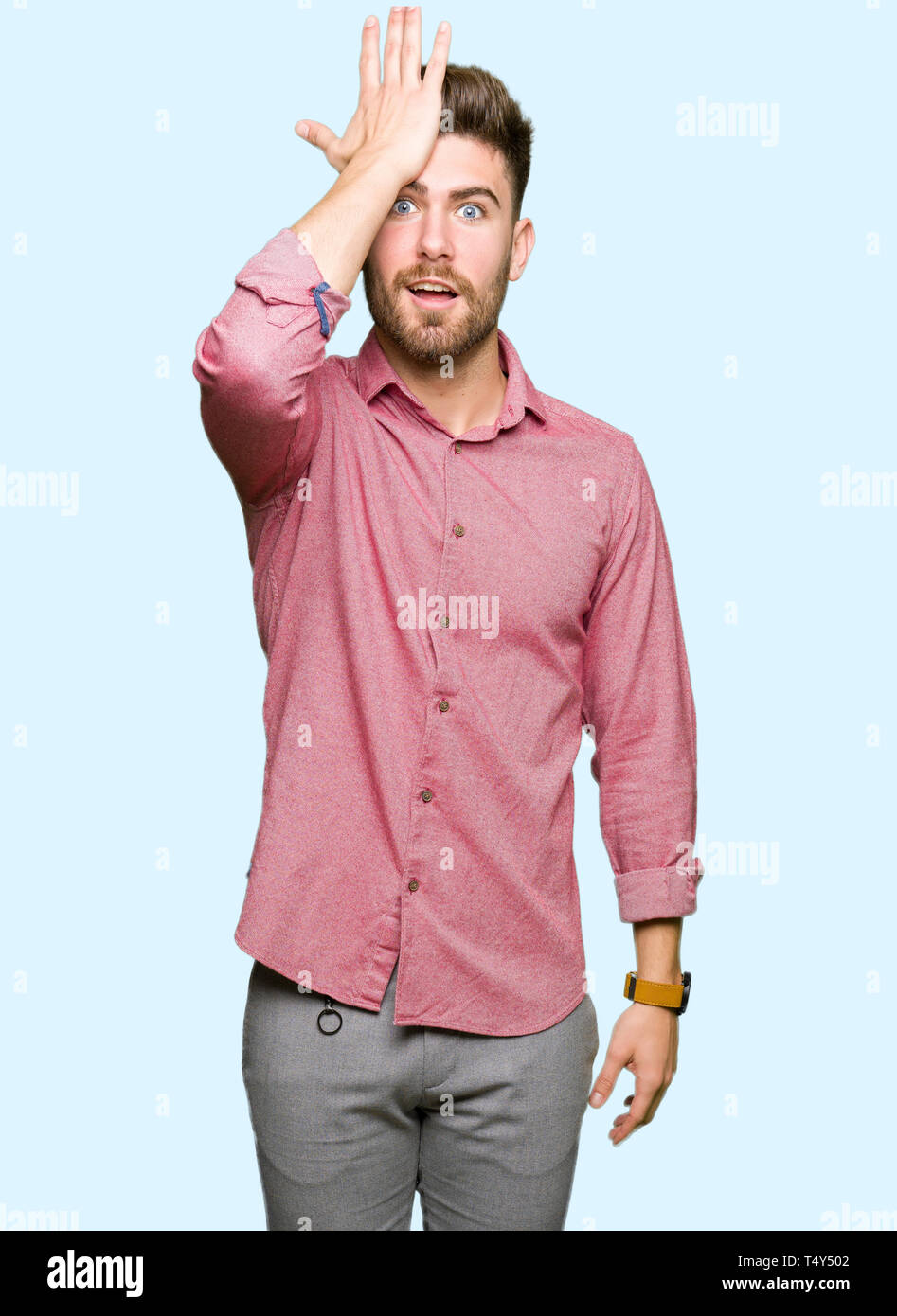 Young handsome business casual man surprised with hand on head for ...