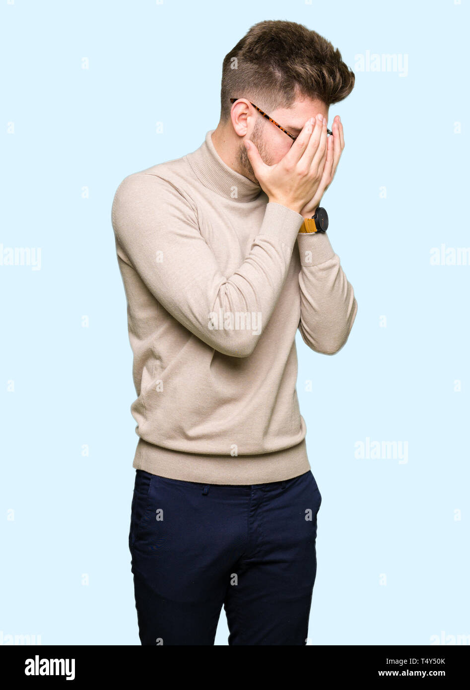 Young handsome business man wearing glasses with sad expression ...