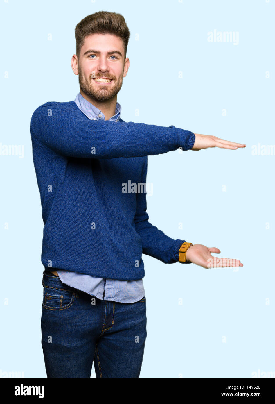 Young handsome bussines man gesturing with hands showing big and large ...