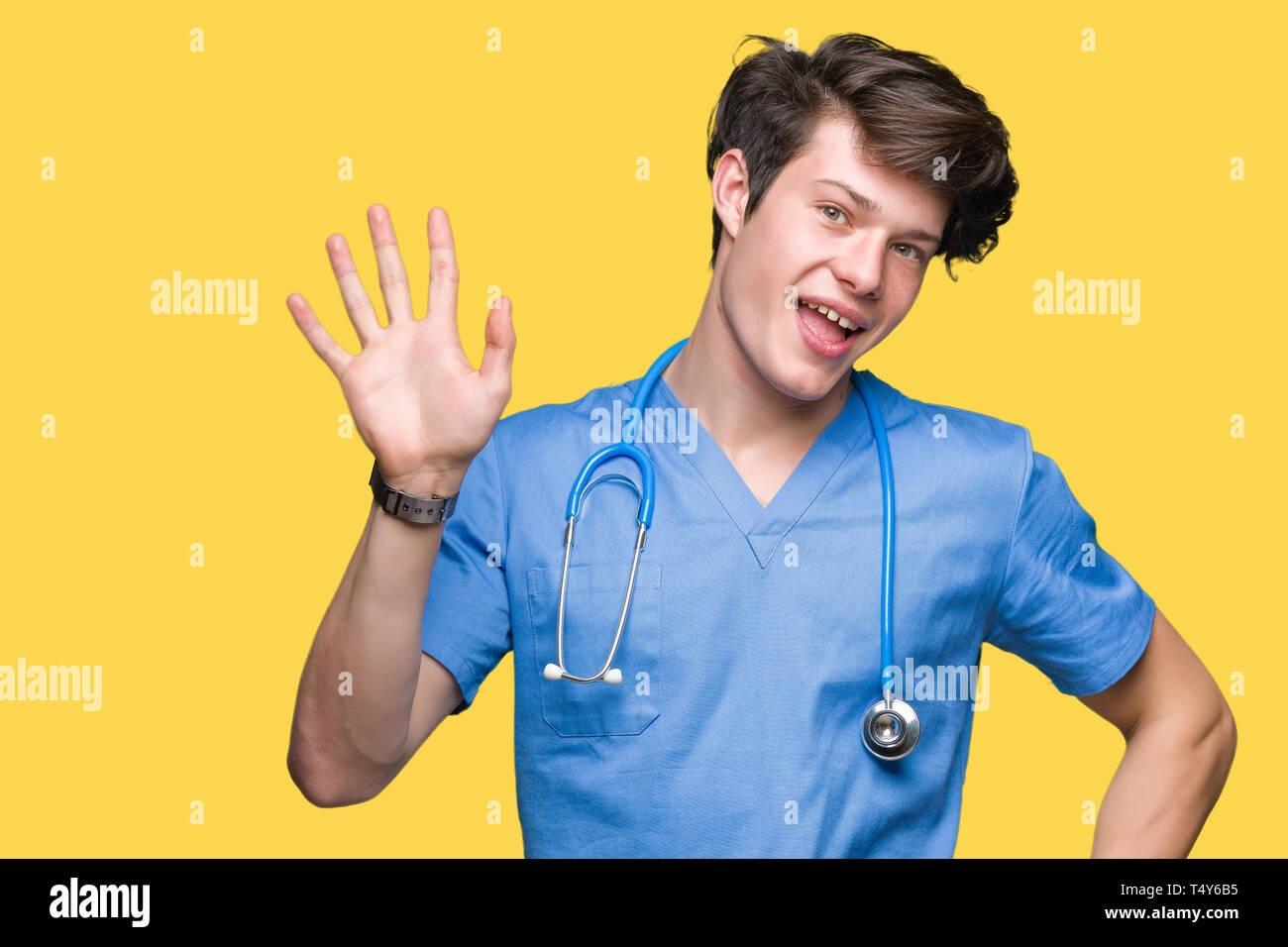 Young doctor wearing medical uniform over isolated background Waiving ...
