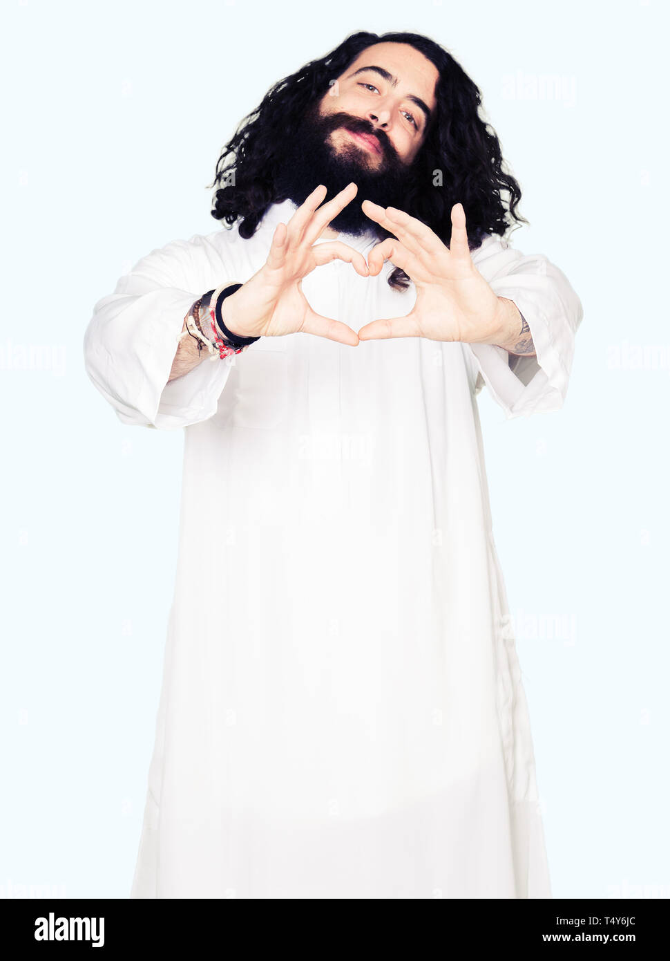 Man wearing Jesus Christ costume smiling in love showing heart symbol ...