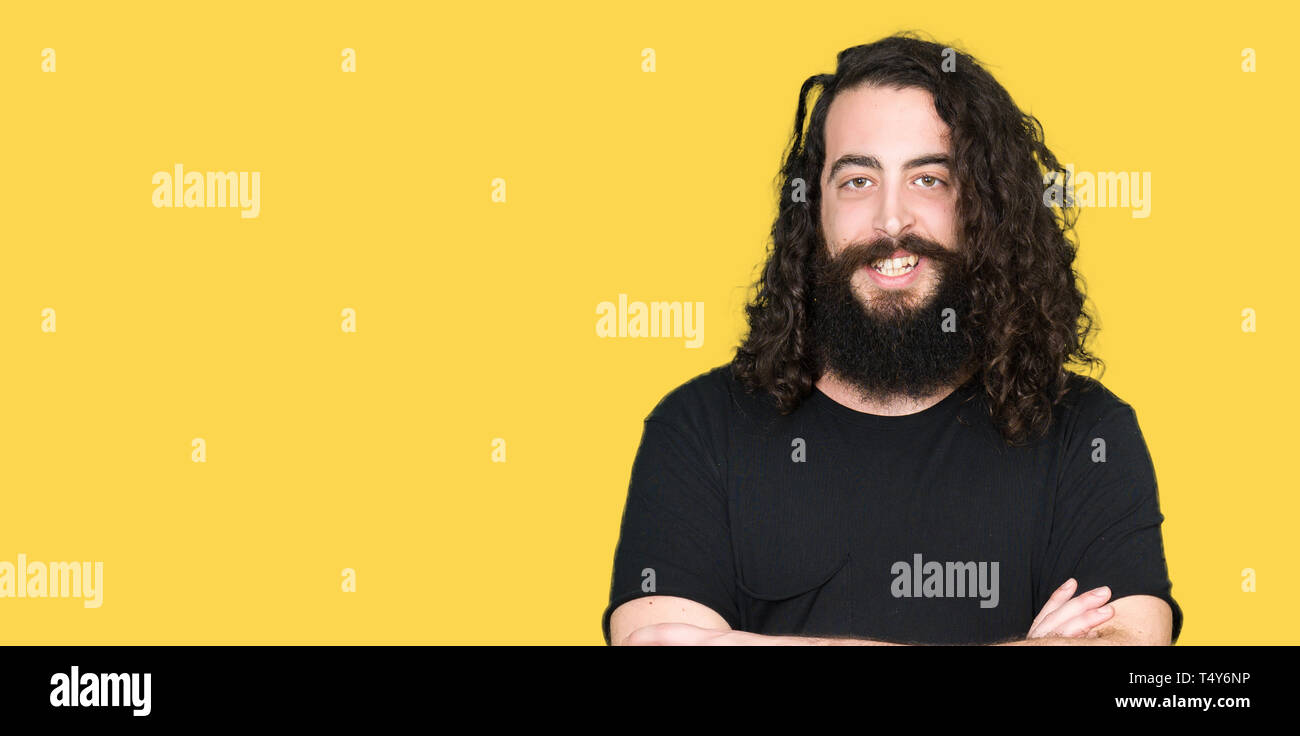 Young man with long hair and beard wearing heavy metal black outfit ...