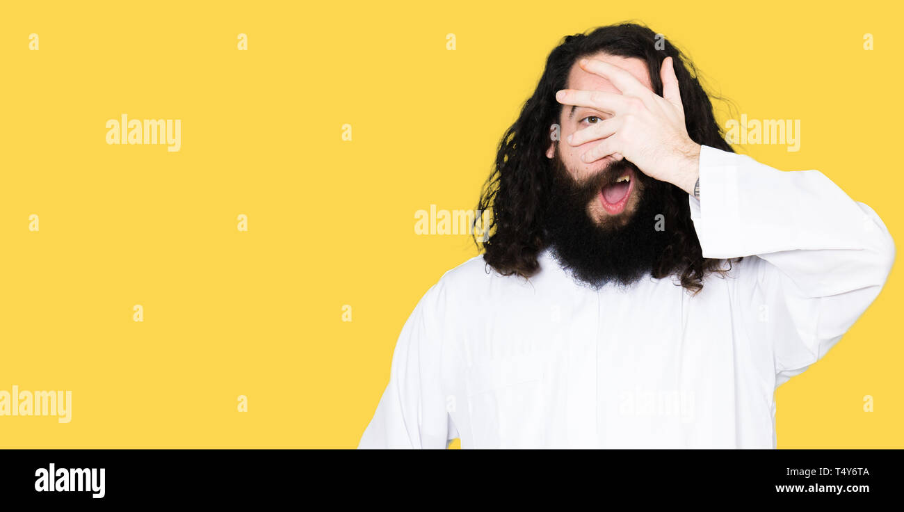 Man wearing Jesus Christ costume peeking in shock covering face and ...