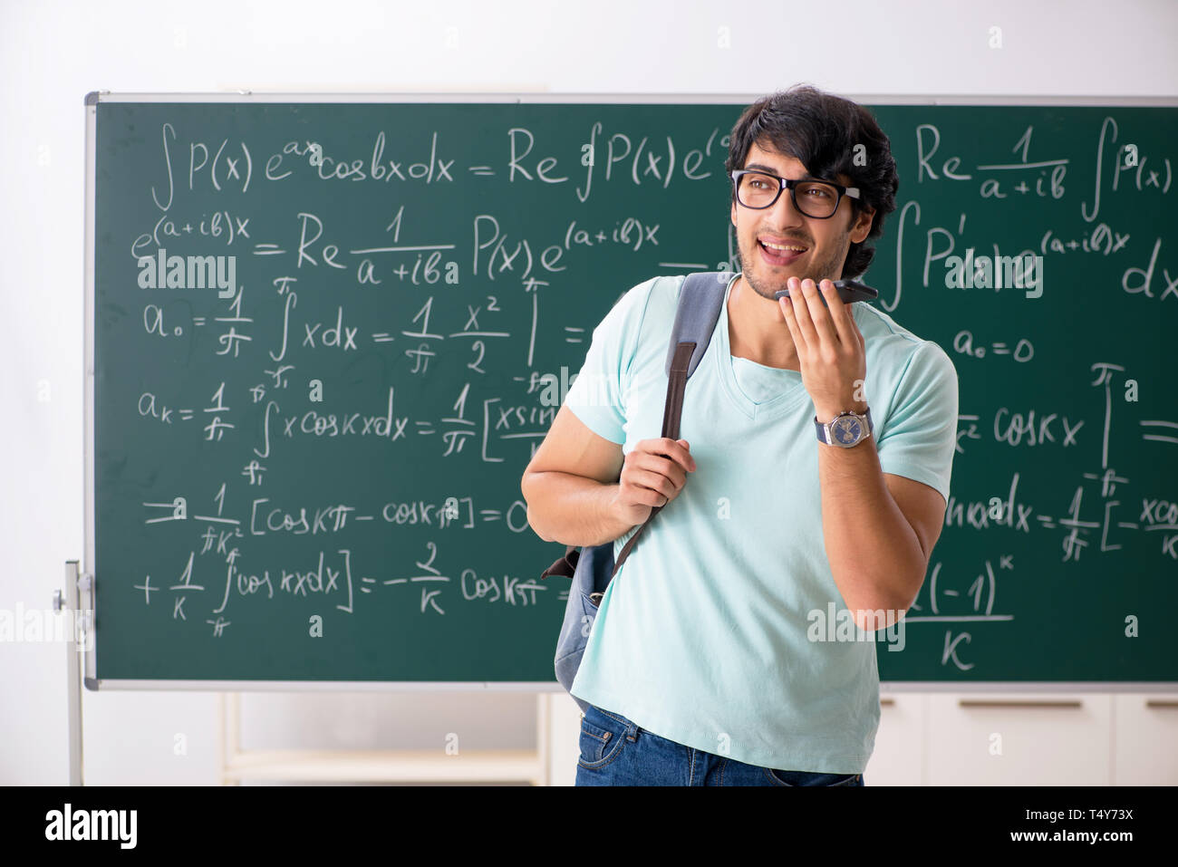 Young male student mathematician in front of chalkboard Stock Photo - Alamy