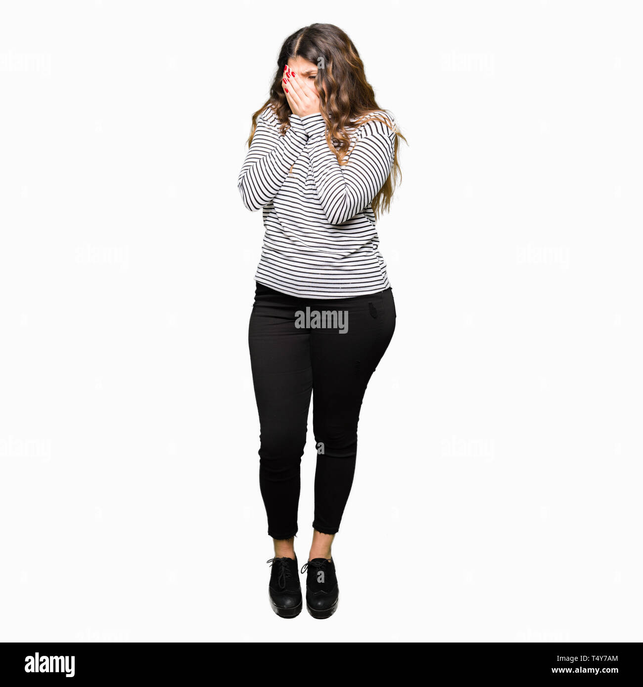 Young beautiful woman wearing stripes sweater with sad expression ...