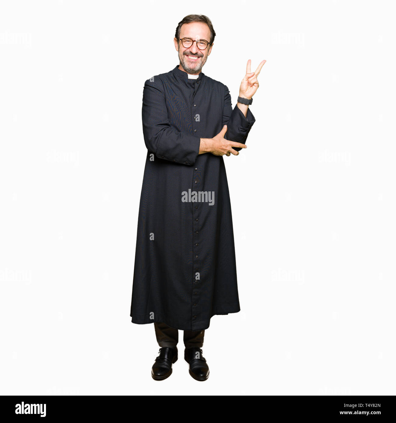 Middle age priest man wearing catholic robe smiling with happy face ...